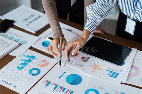 Collaborative Business Woman Meeting Hands Analyzing Financial Charts And Graphs On Office Desk