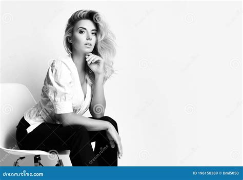 Slim Beautiful Blonde Business Woman Sitting On Office Chair In Casual