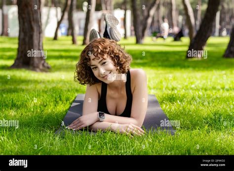 Happy Redhead Woman Wearing Black Sports Bra Standing On City Park