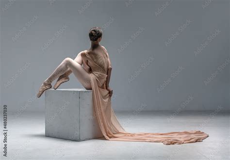 Ballerina Dancing On Ballet Pointe Shoes In Body Color Leotard And Long