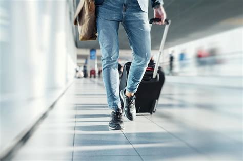 Premium Photo Man With Hand Luggage Walking In Airport