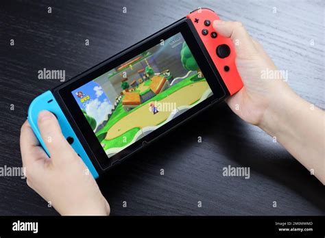 Defocused View To Girl Playing Super Mario Odyssey Game On Nintendo
