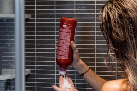 Premium Photo Blonde Woman Throwing Soap On Her Hand In The Shower In