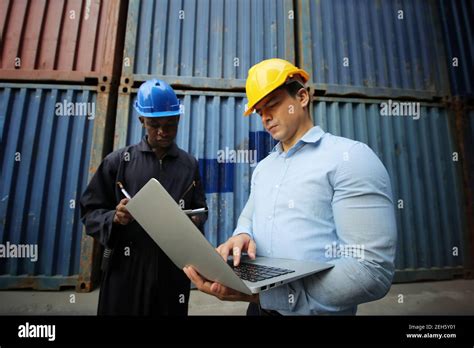Engineer Or Supervisor Checking And Control Loading Containers Box From Cargo At Harbor Foreman
