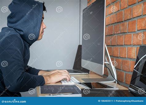 Computer Hacker Or Cyber Attack Concept Dangerous Hooded Hacker Using Multiple Computers Typing