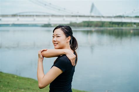 활기찬 젊은 아시아 여자 운동 하 고 아침에 도시 공원에서 팔을 스트레칭 건강관리와 의술에 대한 스톡 사진 및 기타 이미지