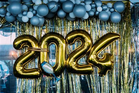 Celebratory Golden Balloons Displaying The Year 2024 Against A Festive
