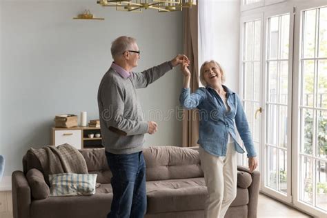 Happy Active Retired Older Couple Training Social Dance At Home Stock