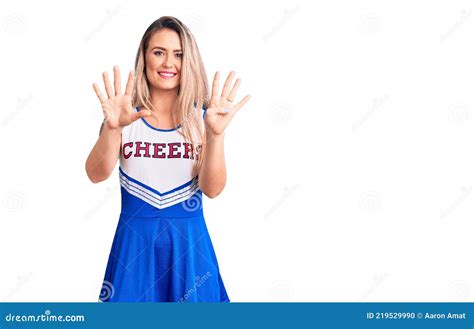 Young Beautiful Blonde Woman Wearing Cheerleader Uniform Showing And