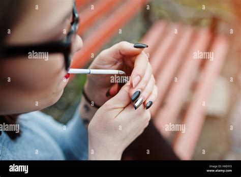 Young Girl Lighting Cigarette Outdoors Close Up Concept Of Nicotine