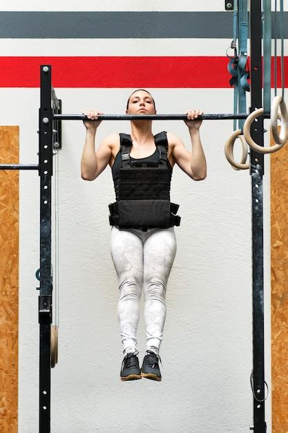 Premium Photo Athlete Doing Weighted Pull Ups On A Bar