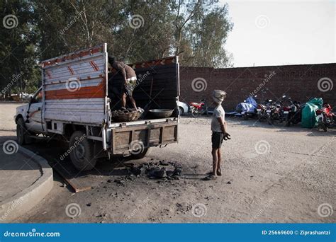 Asian Man Loader Lifting Up The Luggage To Conveyor Belt Of The Trailer To Loading Passenger