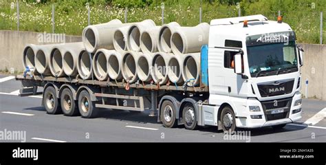 Close Up White Man Hgv Lorry Truck Towing Flat Platform Articulated Trailer Load Of Large