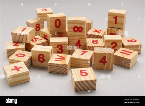 Wooden Cubes With Numbers And Mathematical Symbols On Light Background