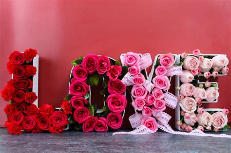 편지 모양의 클로즈업 이미지 빨간색 깊고 밝은 분홍색 장미의 흰색 꽃병 철자 단어 Love 레이스 리본 빨간색 배경 발렌타인