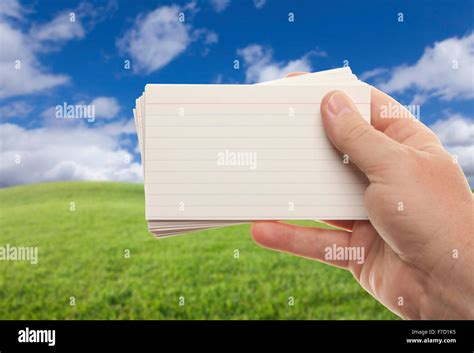 Male Hand Holding Stack Of Flash Cards Isolated On A White Background