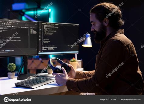 Programmer Putting Headphones While Implementing Security Measures Protect Company Systems