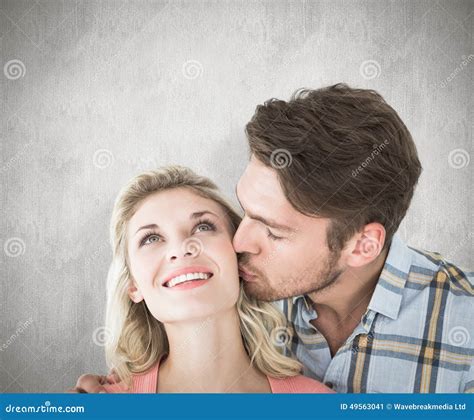 Composite Image Of Handsome Man Kissing Girlfriend On Cheek Stock Image