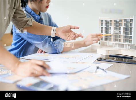 Concept Of Engineering Consulting Two Female Engineers Pointing And Explaining Model Of