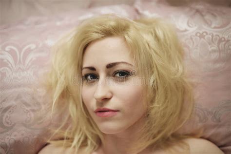 Young Beautiful Girl Wakes Up In The Morning In A Bed Stock Image