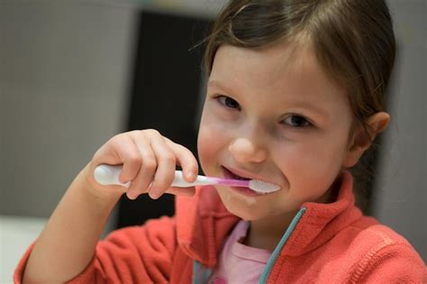Premium Photo Close Up Portrait Of Girl Brushing Teeth At Home