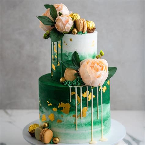 A Green And White Cake With Flowers On Top