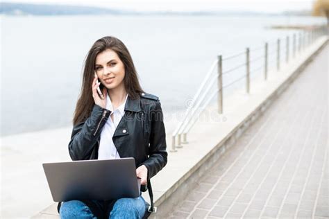 A Young Pretty Girl Dressed In A Leather Jacket And Jeans Spends Time