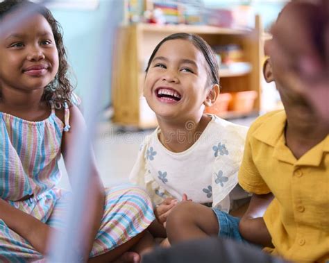 Primary Or Elementary School Class Having Fun With Model Wind Turbine