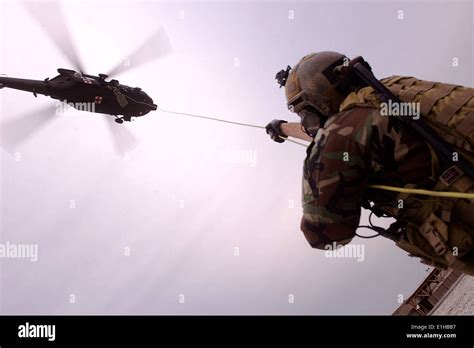 An Afghan National Army Ana Commando Helps Hoist A Litter Into A Uh