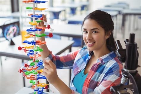 Premium Photo Portrait Of Happy Babegirl Experimenting Molecule Model In Laboratory