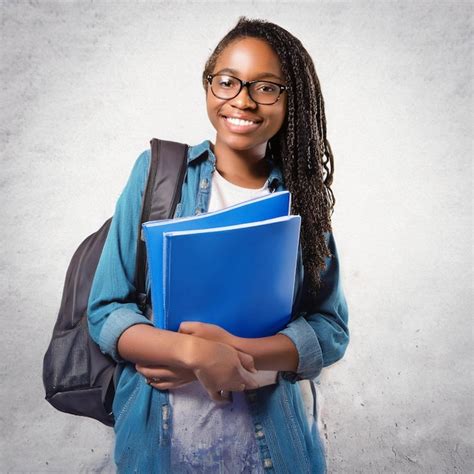 Premium Photo A Girl With A Backpack And A Book On Her Back