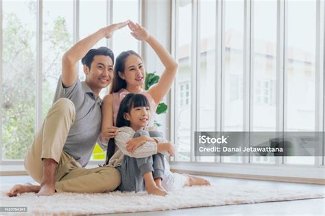 행복한 젊은 아시아 가족 아버지 어머니는 집에서 귀여운 딸과 함께 집 지붕을 형성합니다 가족 이주 또는 보험 보호 개념 가족에