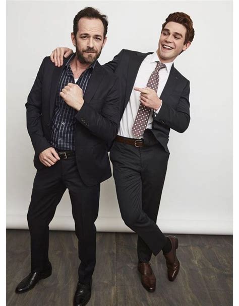 Two Men Posing In Suits And Ties