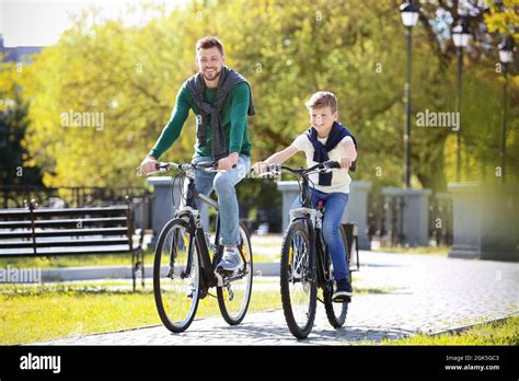 Dad And Son Riding Bicycles Outdoors Stock Photo Alamy