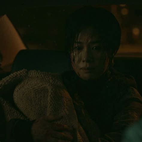A Woman Sitting In The Back Seat Of A Car With Her Arm Wrapped Around A