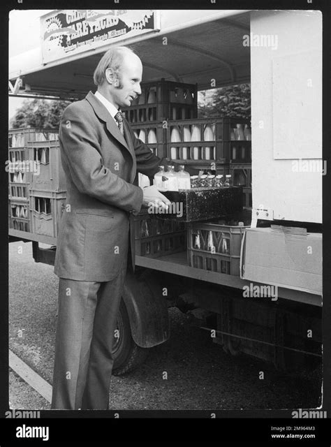 A British Government Inspector Quality Checking Bottles Of Milk On
