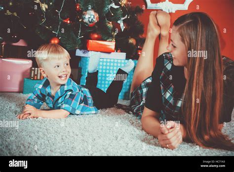 Beautiful Portrait Of Happy Mother And Son On The Background Of The Christmas Tree In New Year