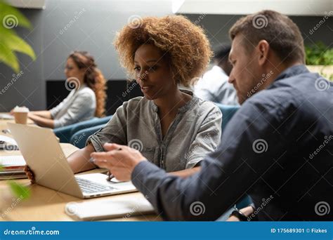 Serious Businessman Mentor Teaching African American Businesswoman