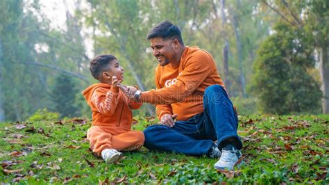 Cheerful Indian Father And Son Enjoying Outside In The Park Fatherhood