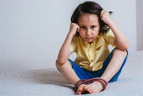Premium Photo Little Oy With Foot Tied Up With Rope In Emotional Stress