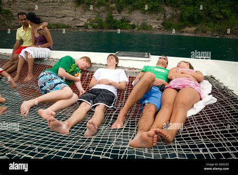 Tired Teenagers Sleeping On A Catamaran St Lucia West Indies Stock