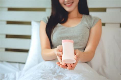 Asian Woman Applying Lotion And Cream On Hands And Arms To Add Moisture