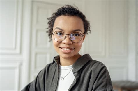 Premium Photo Confident Young Woman With Glasses And Curly Hair