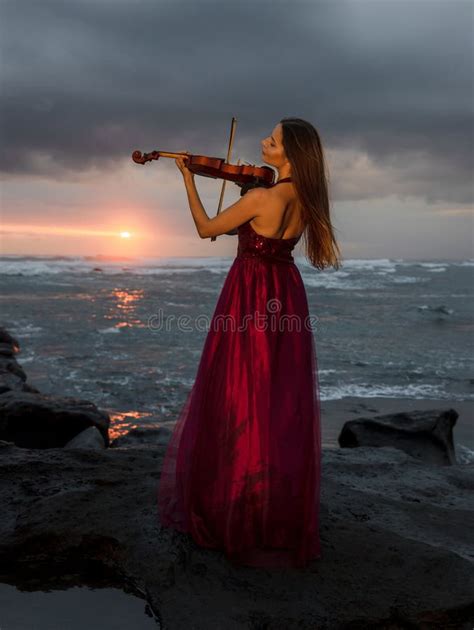 Beautiful Caucasian Woman With Violin On The Beach Music And Art