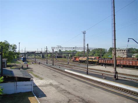Image Depicts A Train Depot Or Maintenance Facility During Daytime With Multiple Sets Of