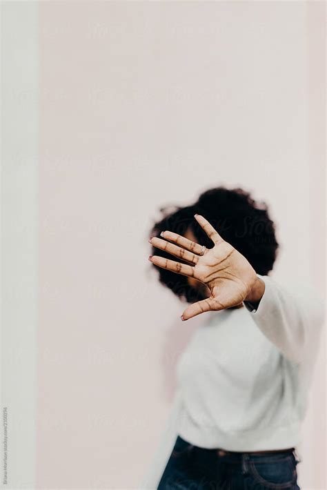 Woman Holding Her Hand Up In Front Of Her Face By Stocksy Contributor