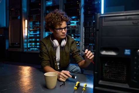 Young It Technician Repairing Computer In Modern Data Center Stock