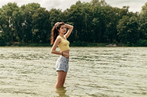 Premium Photo Slim Woman Walking Barefoot Along The River Sea Lake