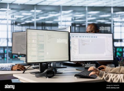 Lines Of Code Running On Computer Screens In Data Center Used By Employees To Troubleshoot