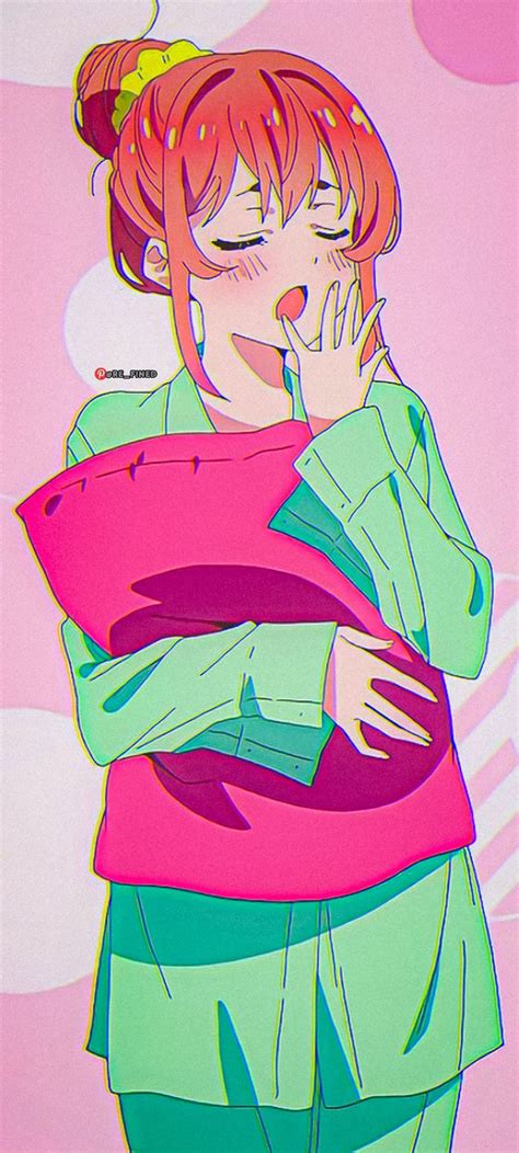 A Woman Hugging Her Face While Wearing A Pink Shirt And Green Pants In